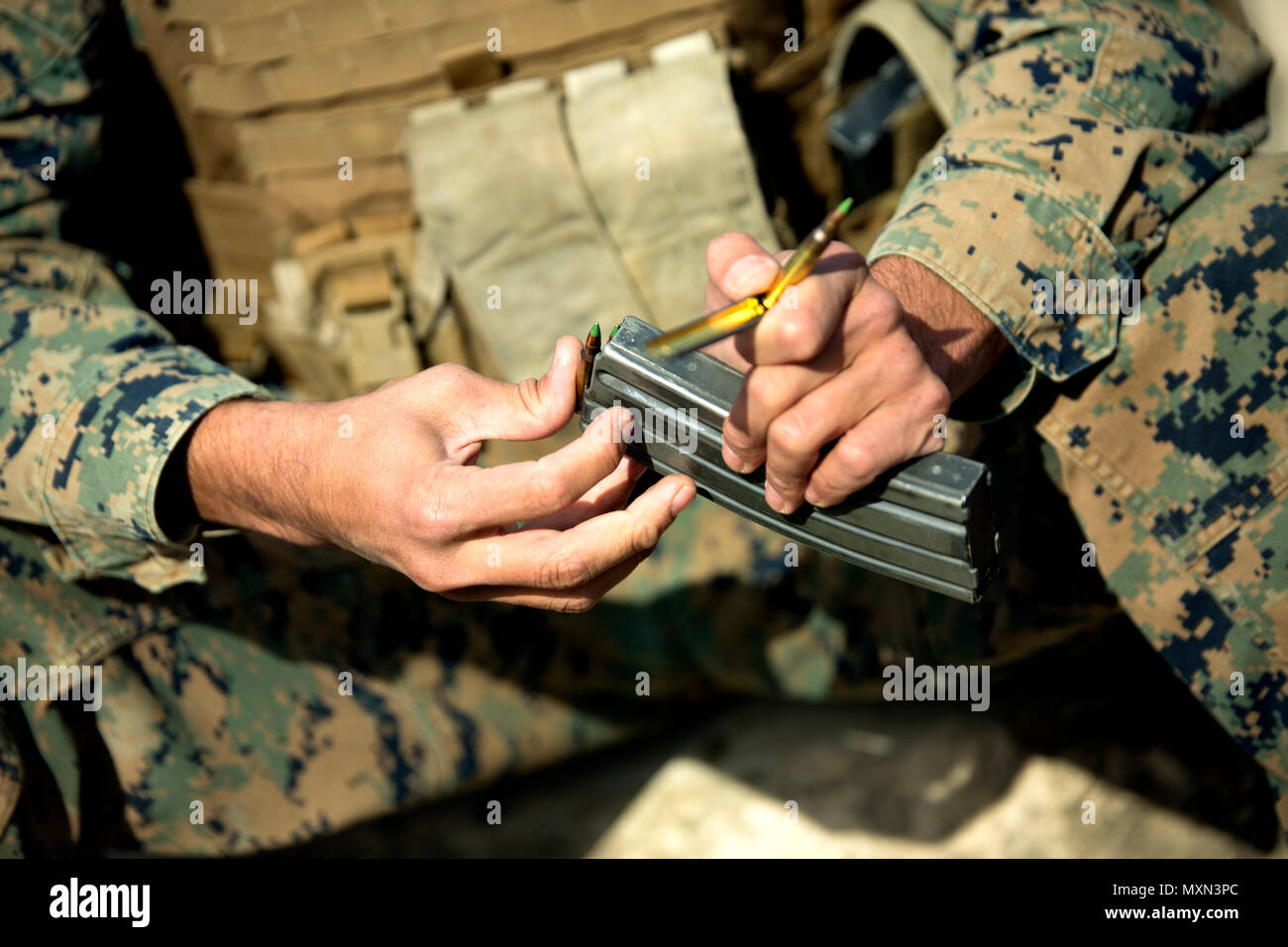 A U.S. Marine loads his magazines during Korean Marine Exercise Program ...