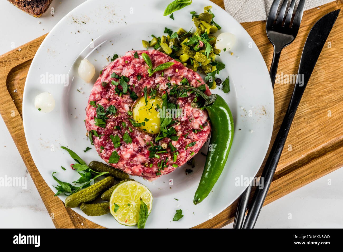 French cuisine, beef steak tartare with raw quail egg yolk, pickled ...