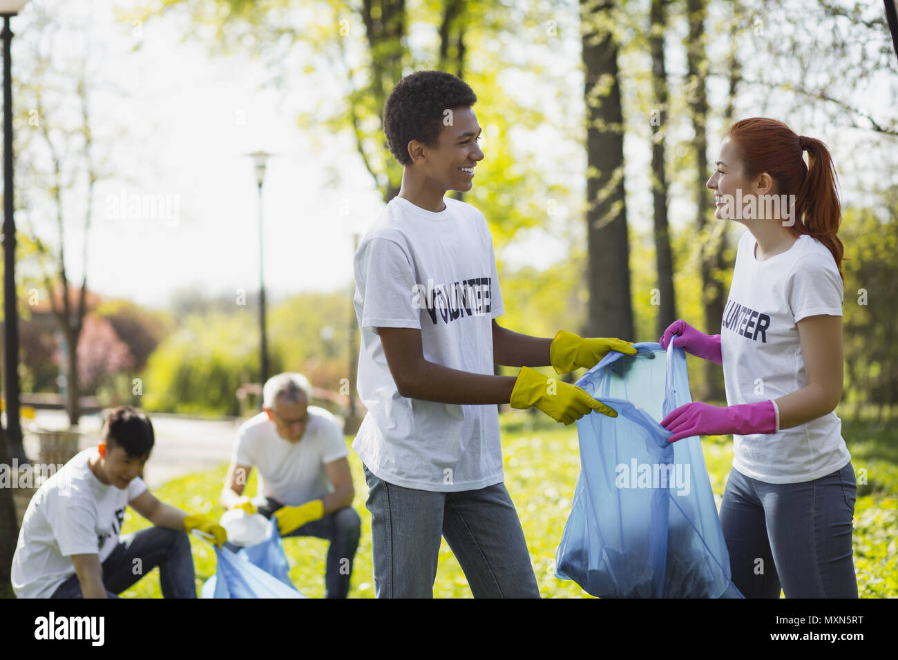 Happy two volunteers protecting environment Stock Photo - Alamy