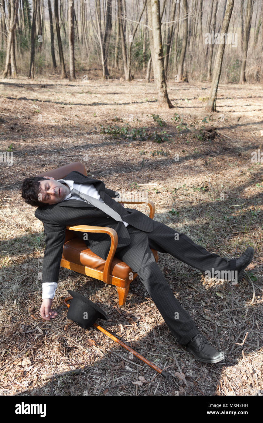 man alone in the woods sitting on a armchair Stock Photo - Alamy