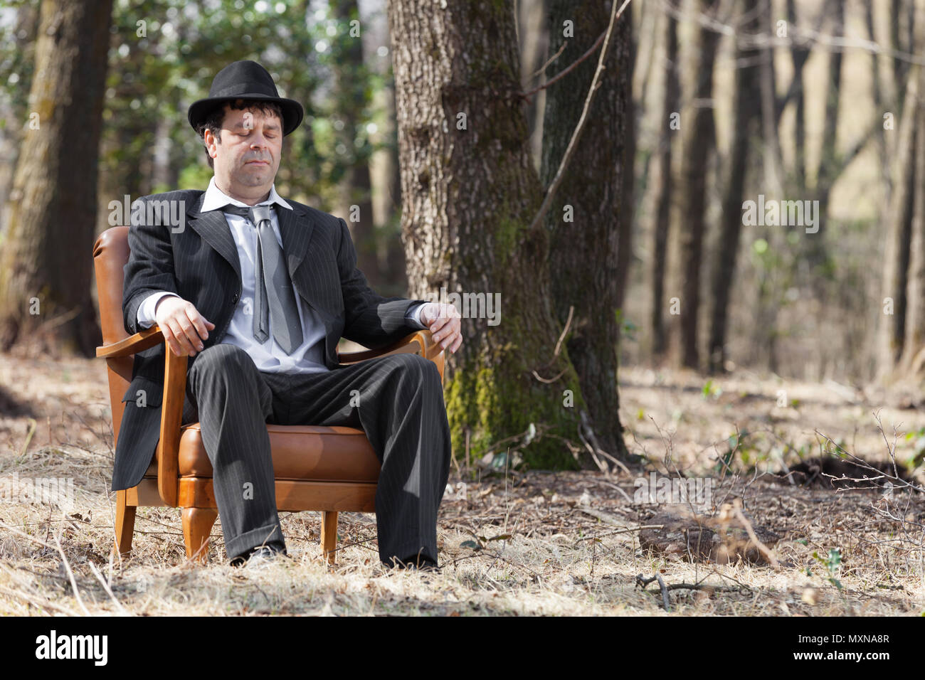 man alone in the woods sitting on a armchair Stock Photo - Alamy
