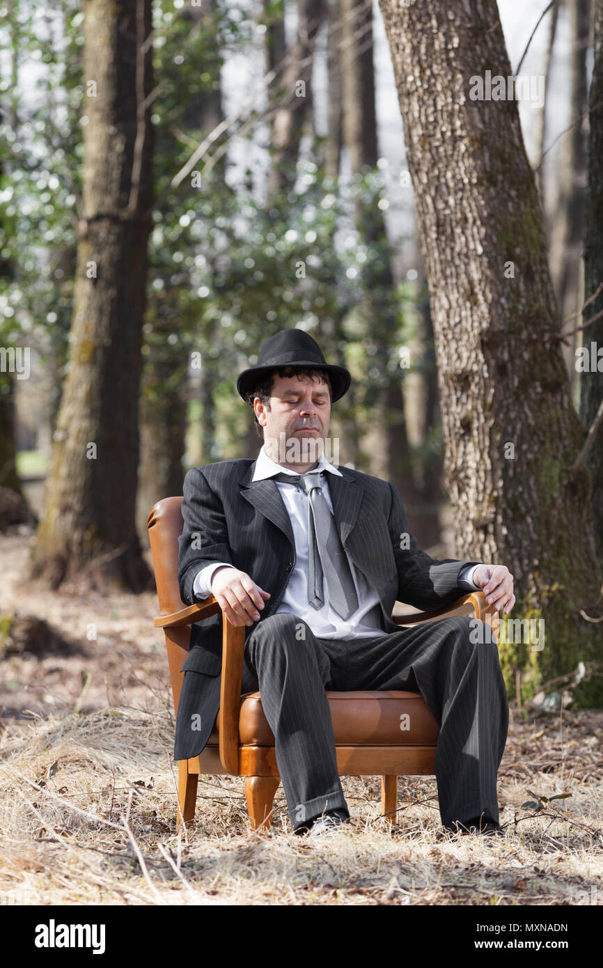 Sitting on an armchair hi-res stock photography and images - Alamy