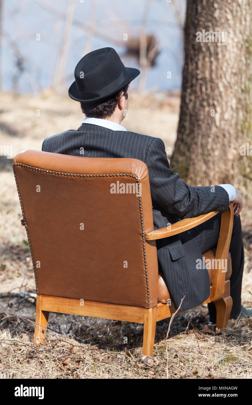 Back view of a man sitting on a chair hi-res stock photography and ...