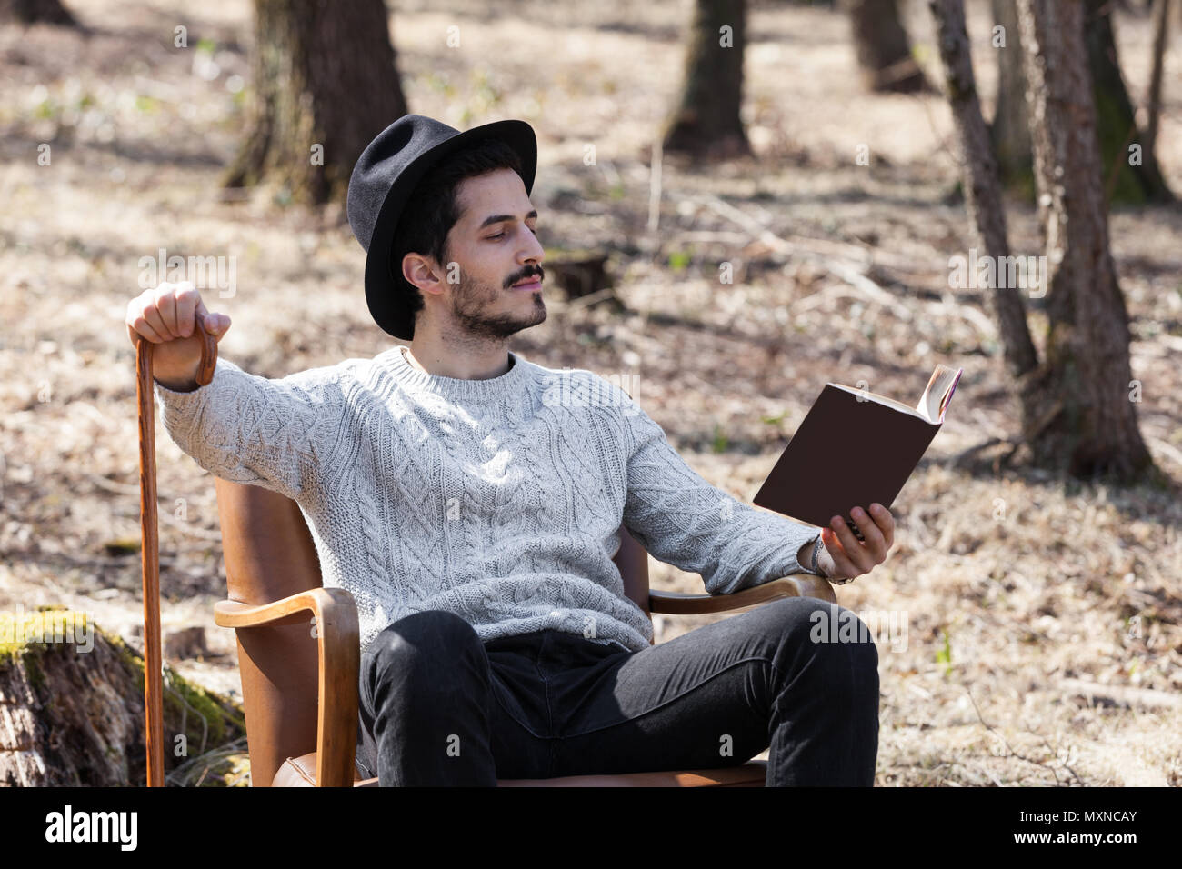 man reading a novel in the woods, portrait Stock Photo - Alamy