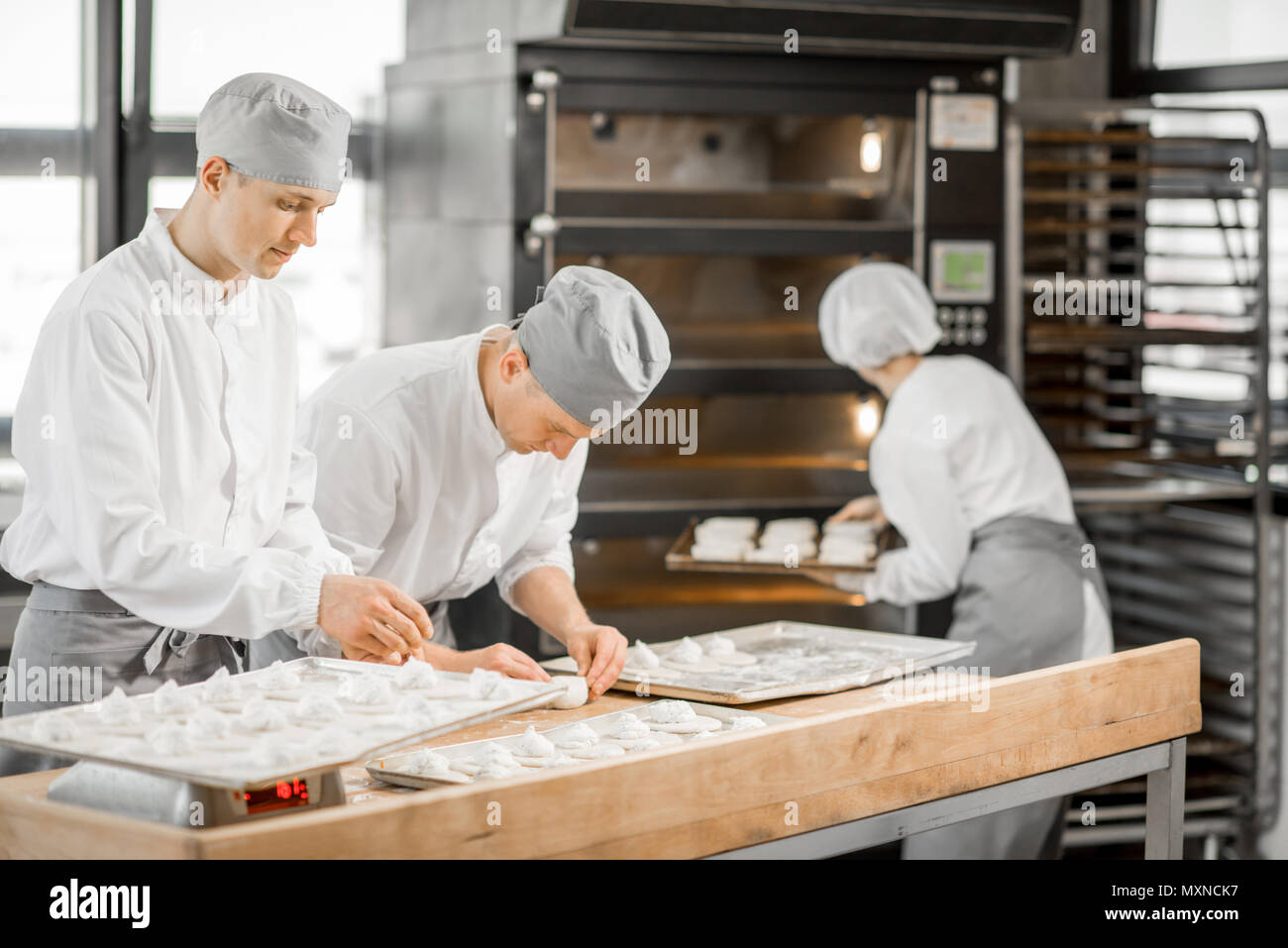 Bakers making buns at the manufacturing Stock Photo - Alamy