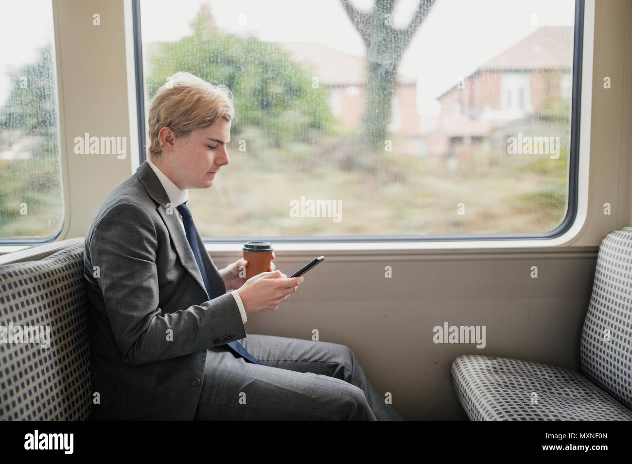 Businessman on his morning commute to work on the train. The young ...