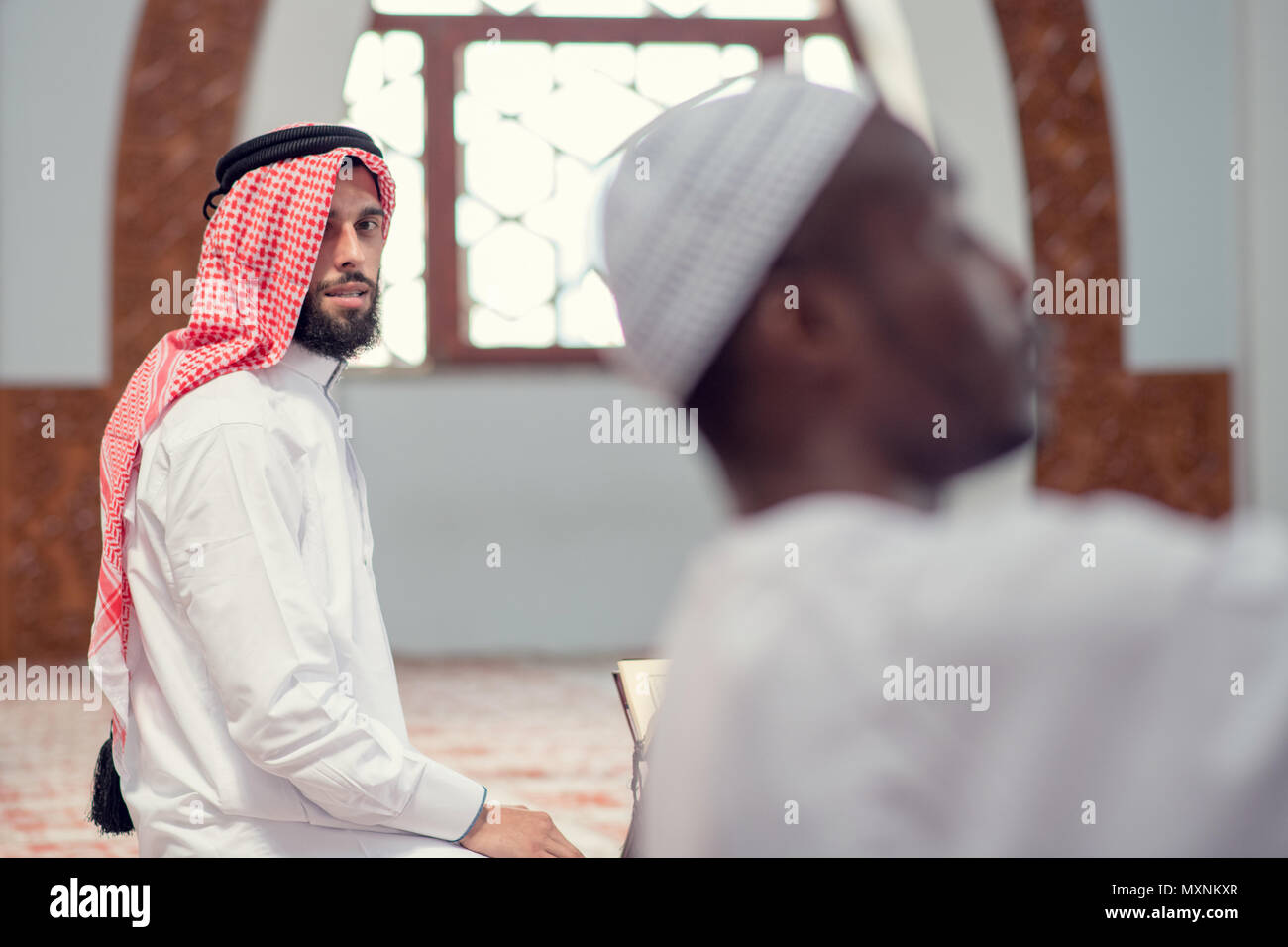 Two religious muslim man praying together inside the mosque Stock Photo ...