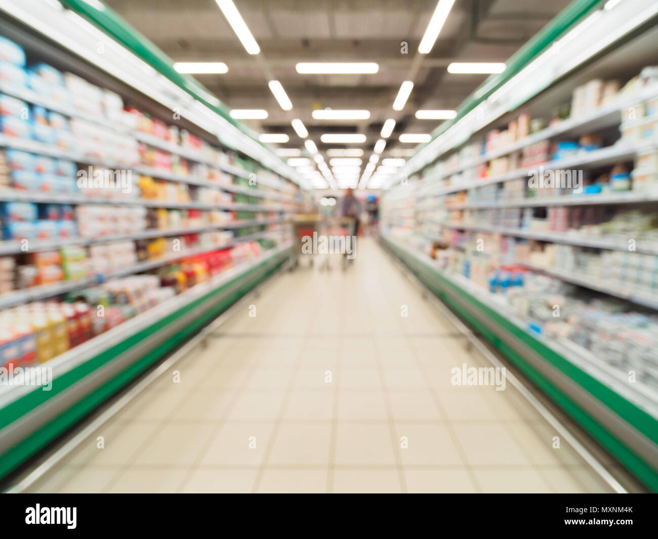 Abstract blurred supermarket aisle with colorful shelves and ...