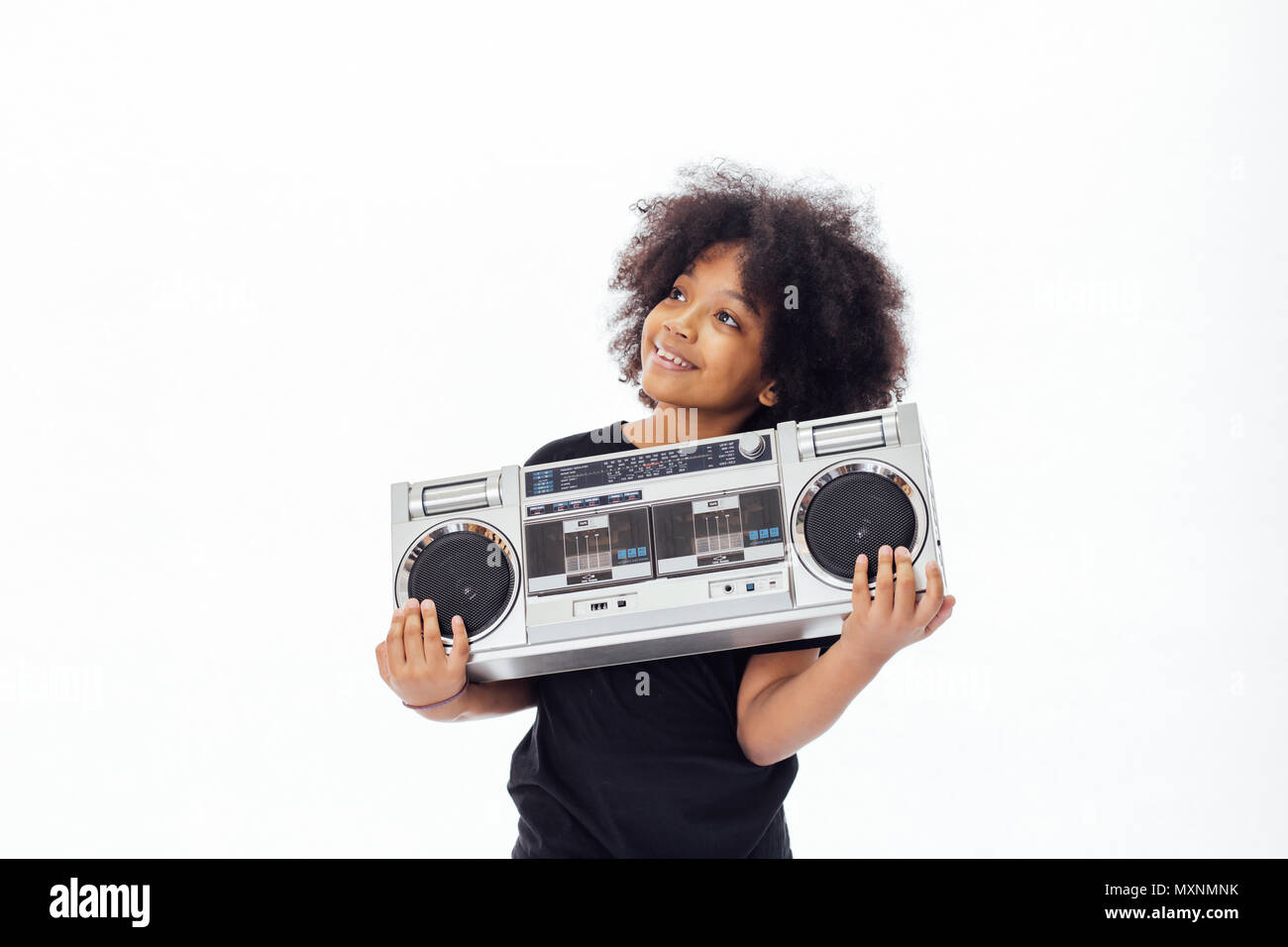 Cute and smiling African American kid holding a musical jukebox ...