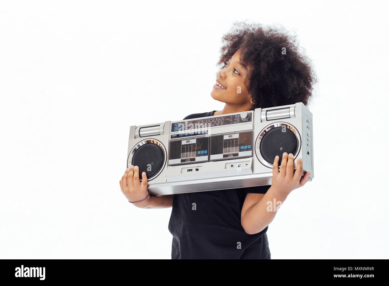 Cute and smiling African American kid holding a musical jukebox ...