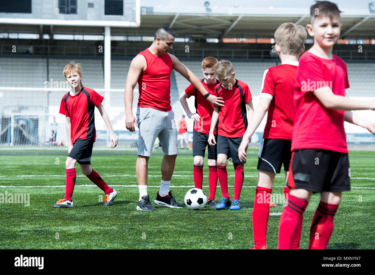 Coach Teaching Football Team Stock Photo - Alamy