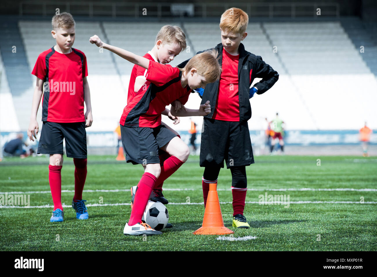 Child playing football in stadium hi-res stock photography and images ...