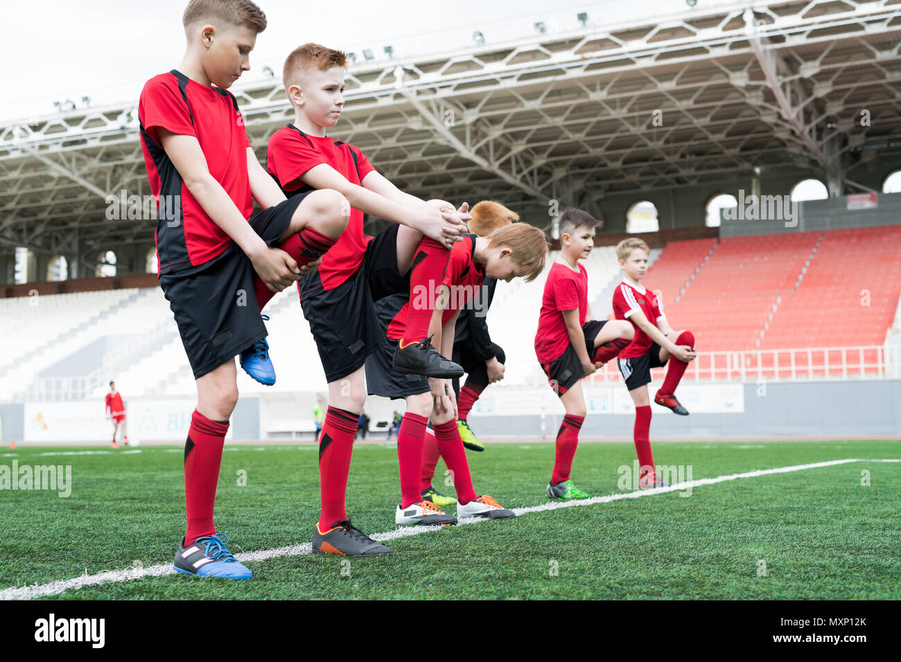 Football Team Stretching before Practice Stock Photo - Alamy
