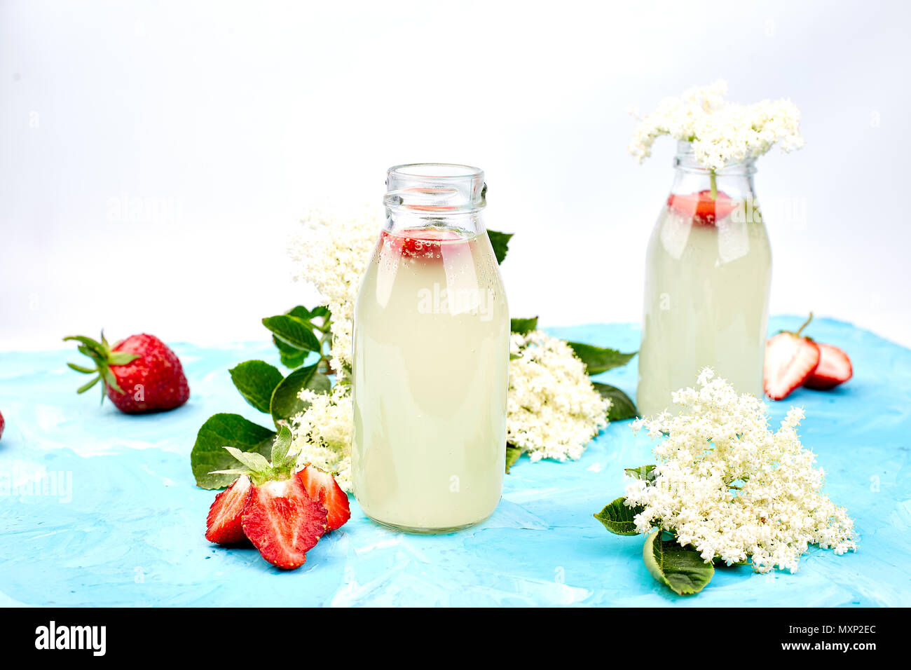 Kombucha Tea With Elderflower And Strawberry On Blue Background