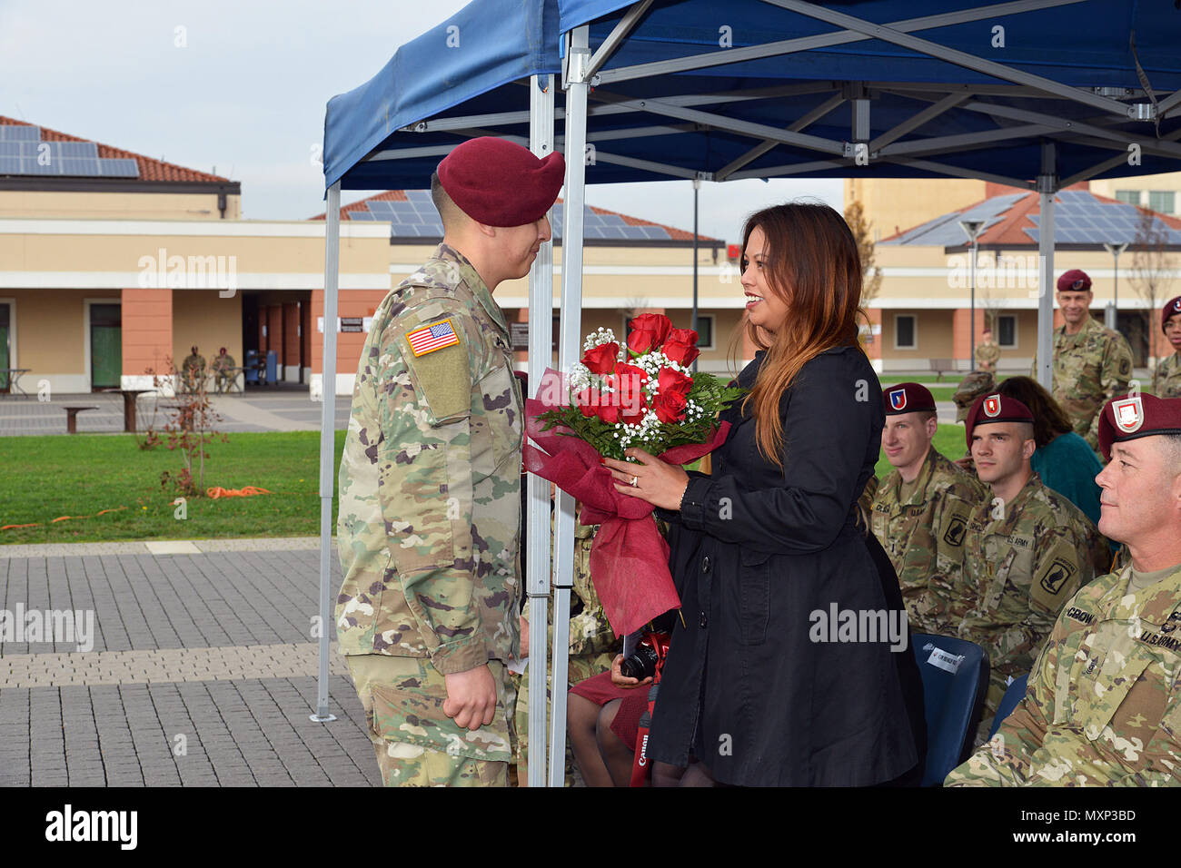 Wife of outgoing Command Sgt. Maj. Travis C. Crow receives a bouquet of ...