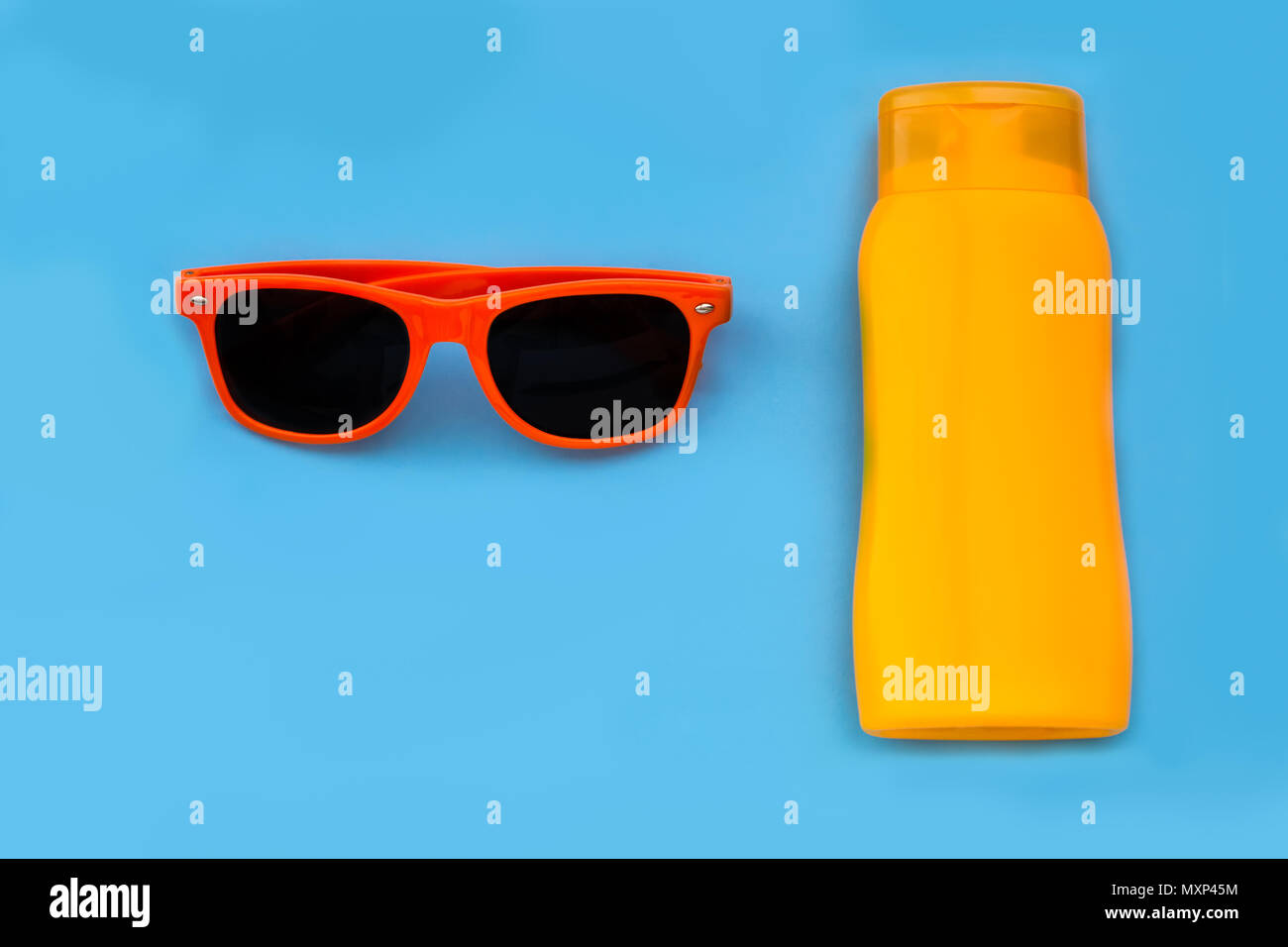 Orange sunglasses and orange bottle of suncream or sun lotion isolated ...