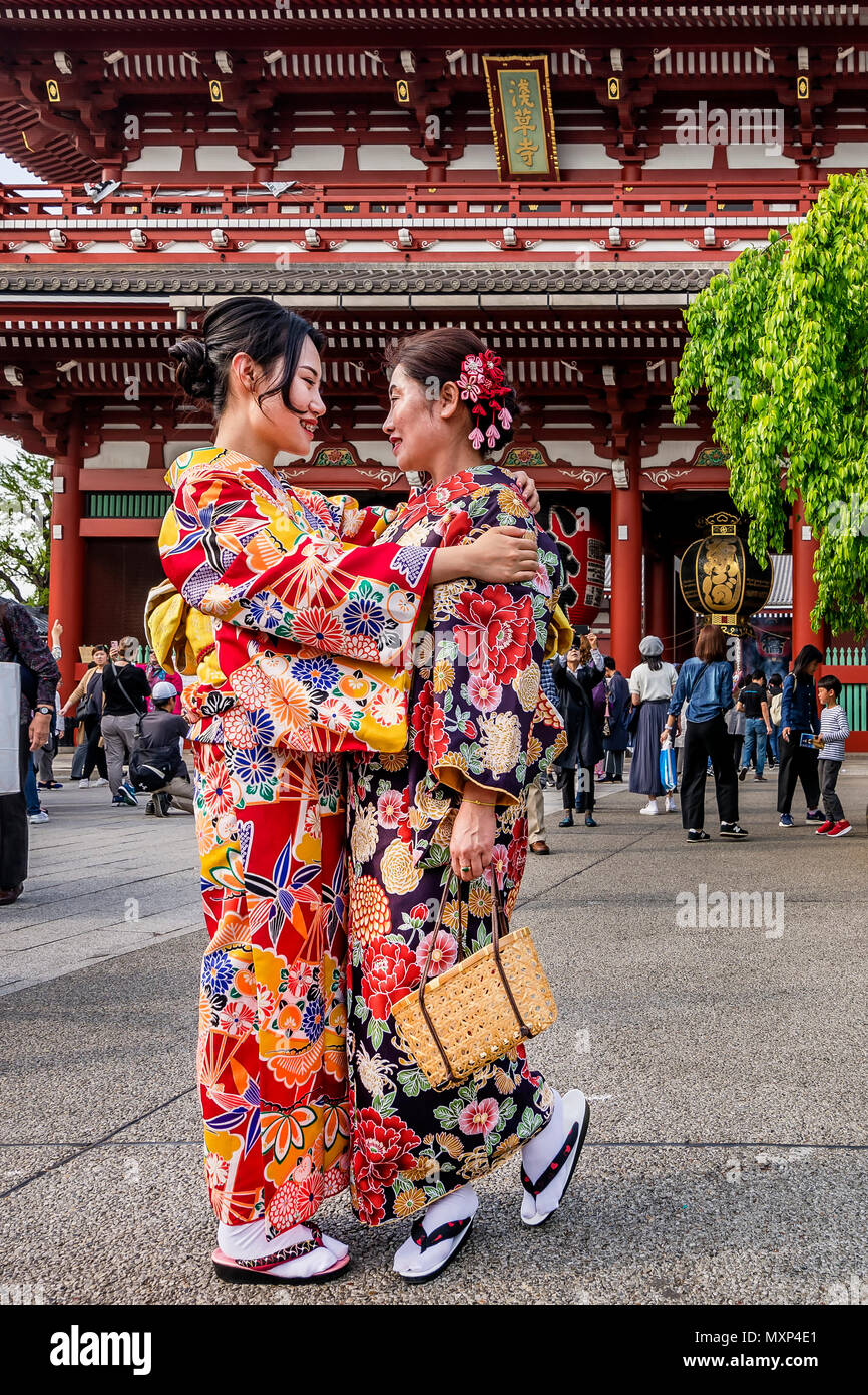 Two women in traditional Japanese clothes hug each other tenderly in ...