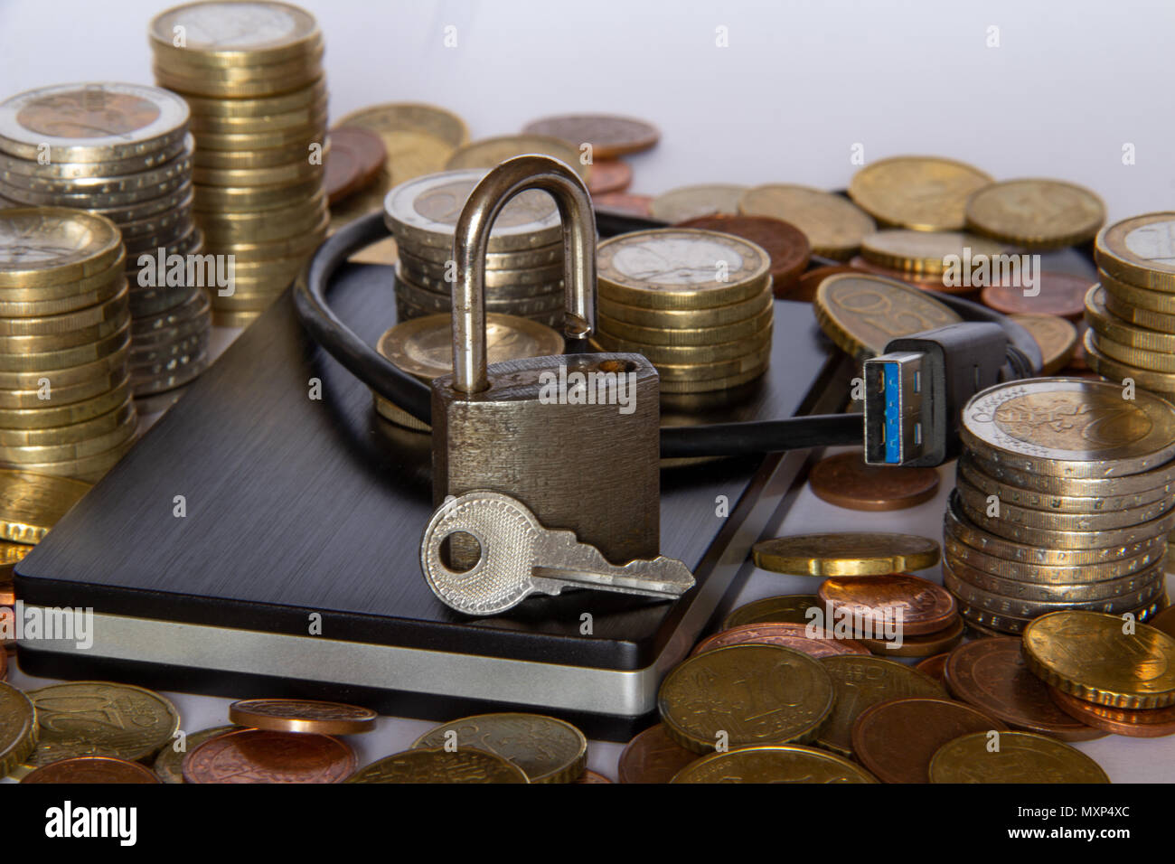External hard drive and a pile of money in front of a White background ...