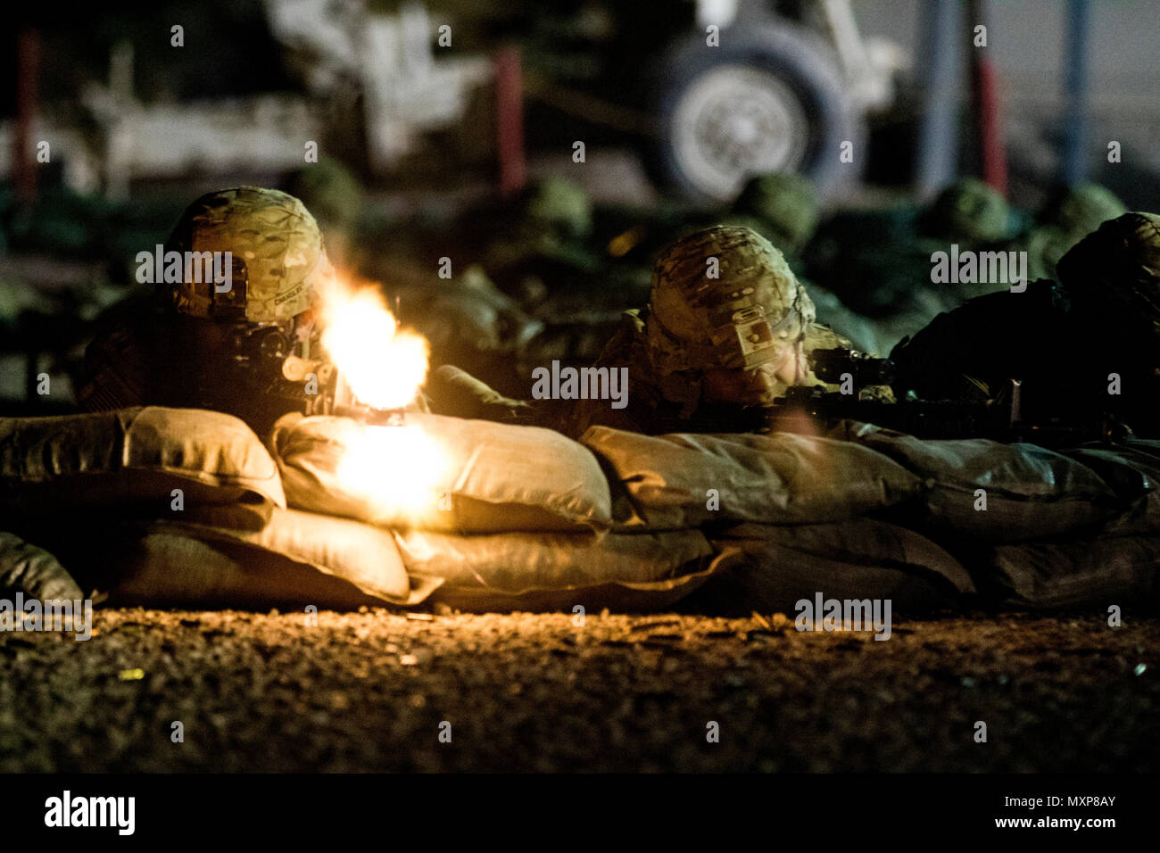 Soldiers from the 2nd Engineer Battalion fire from fighting positions ...