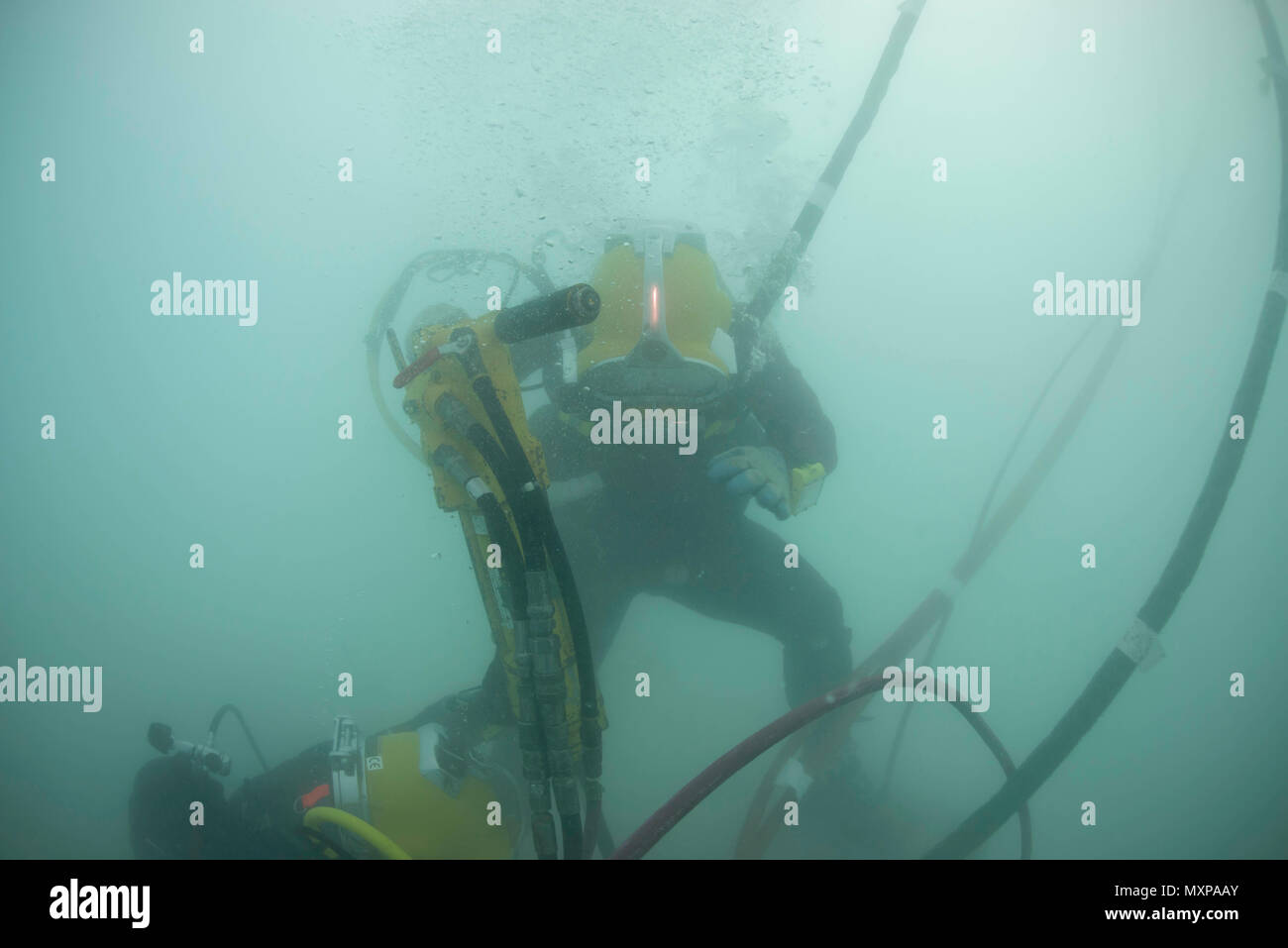 Petty Officer 1st Class Matt Ramirez, center, assigned to Underwater ...