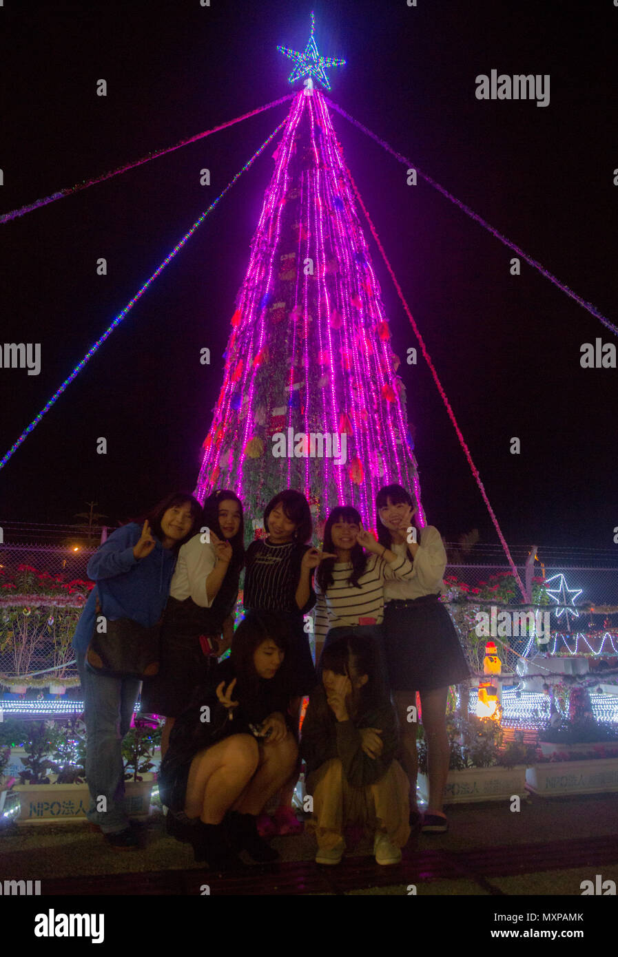 Kin Town locals pose for pictures and admire the lighting of a ...