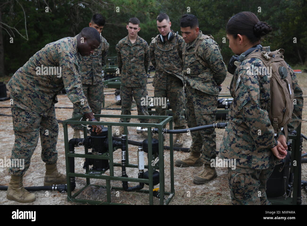 Staff Sgt. Sheldon Dias instructs Marines on how to operate the light ...