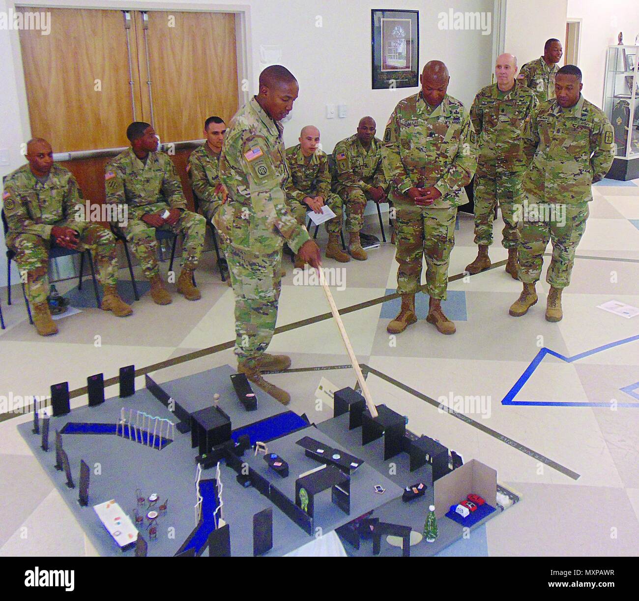 A noncommissioned officer briefs Command Sgt. Maj. Jimmy Sellers ...