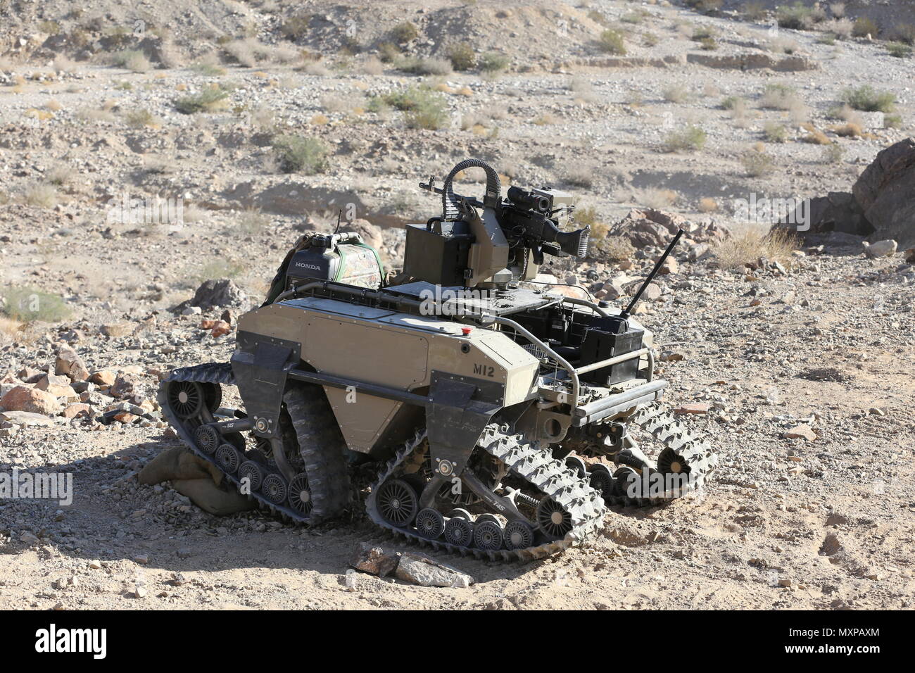 A Weaponized Multipurpose Unmanned Tactical Transport (W-MUTT) provides ...