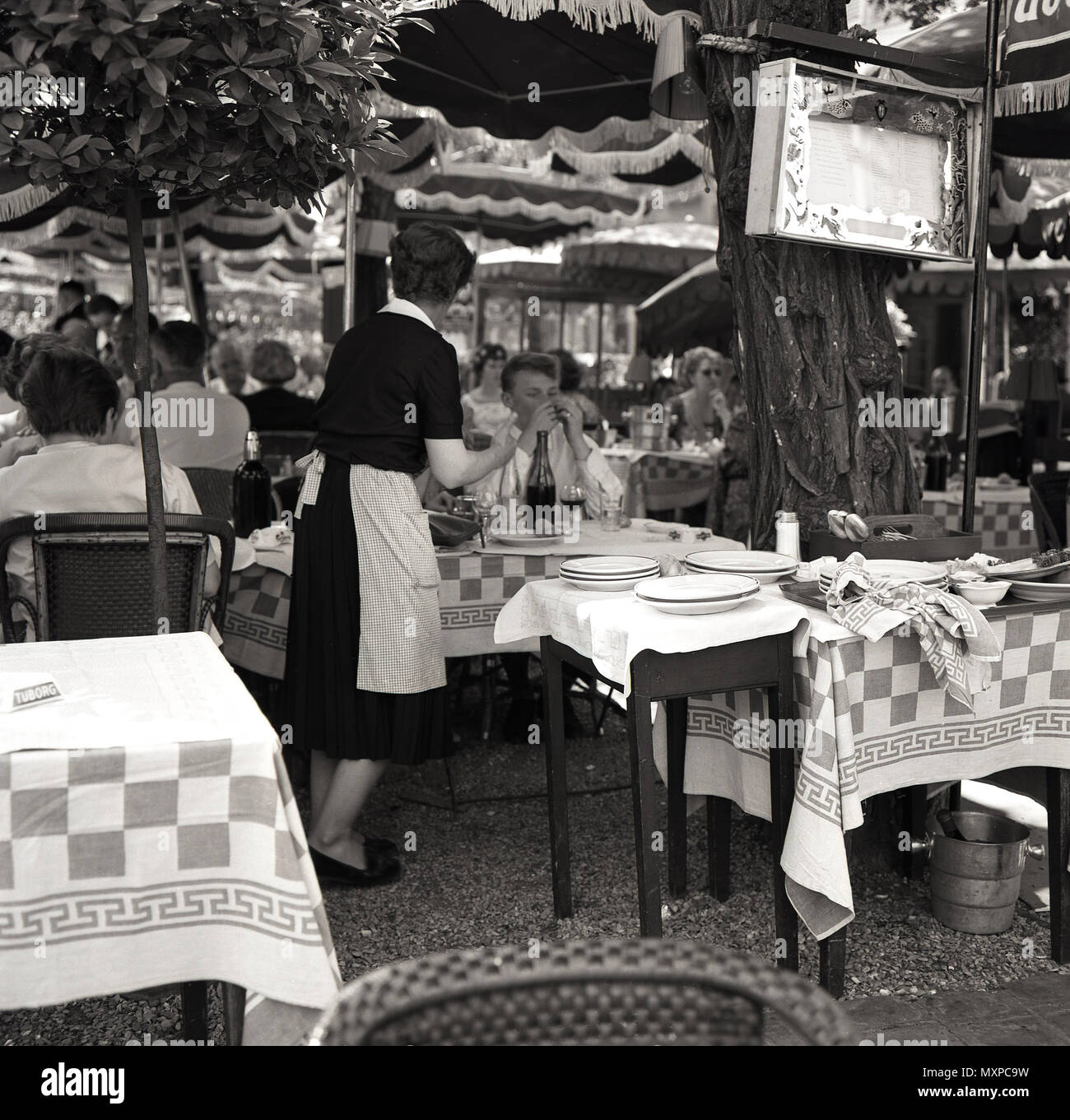 1950s, historical, a female waitress serving dinning customers outside ...