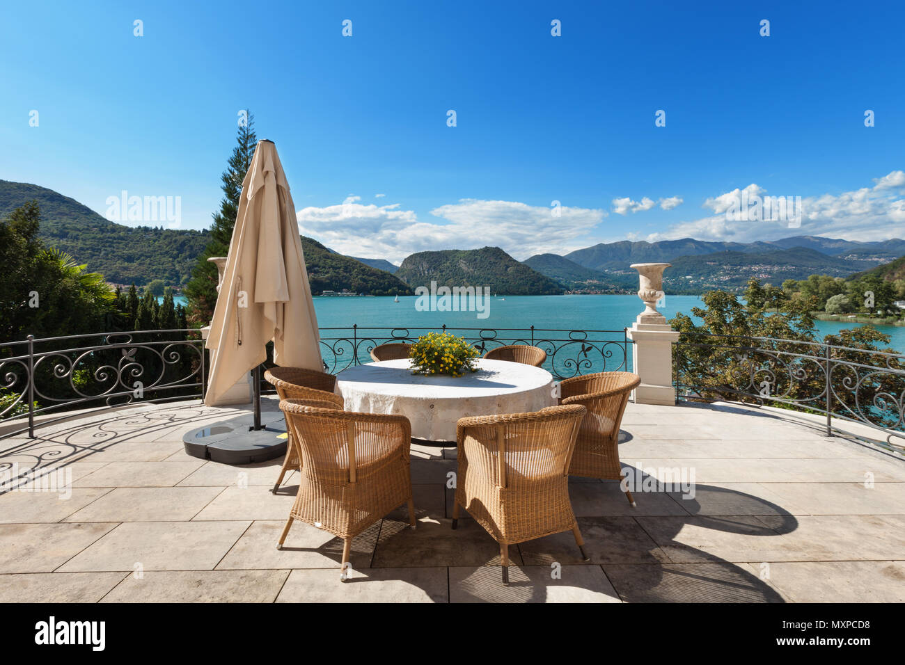 external of a luxury mansion, beautiful terrace overlooking the lake ...