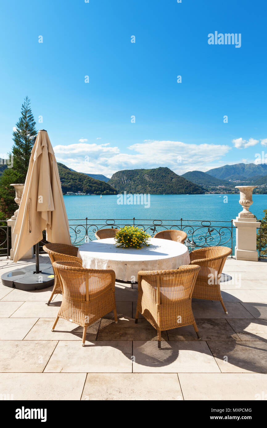 external of a luxury mansion, beautiful terrace overlooking the lake ...