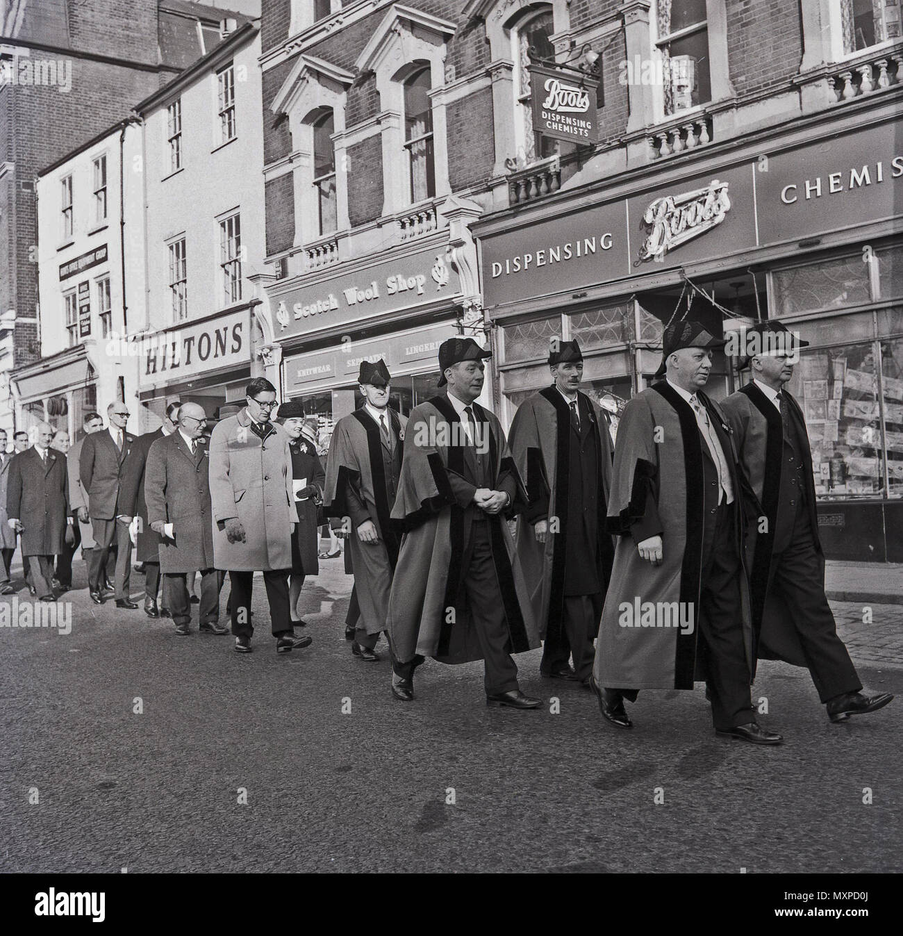 1964, people, including local dignitaries walking in a "best of british ...