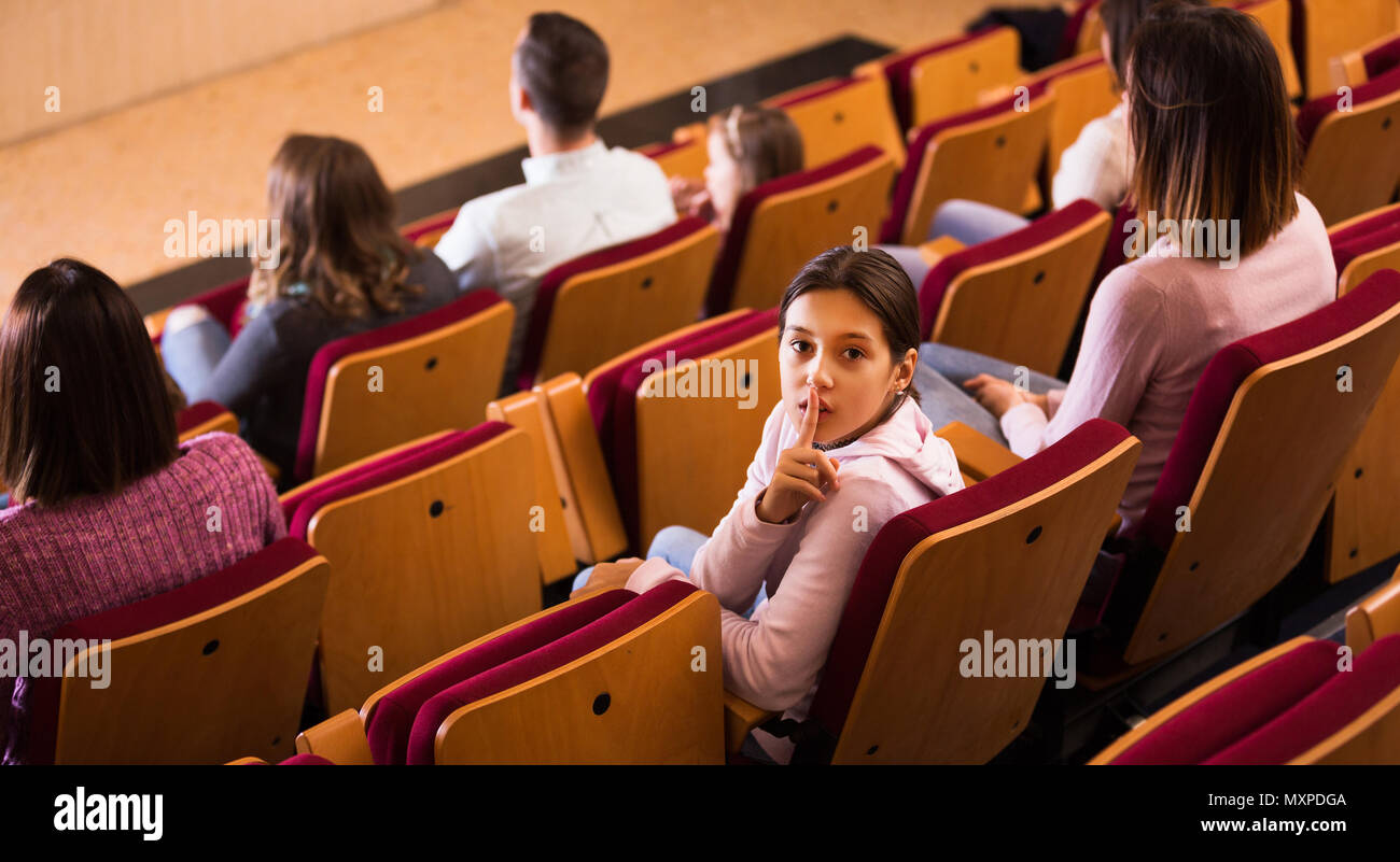 Female teenager looking away from screen in cinema house Stock Photo ...