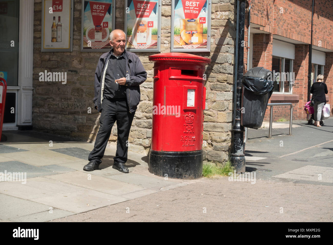 A smoking man, a post box Stock Photo - Alamy