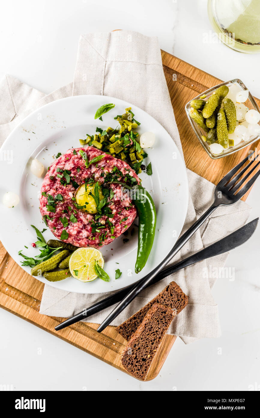 French cuisine, beef steak tartare with raw quail egg yolk, pickled ...