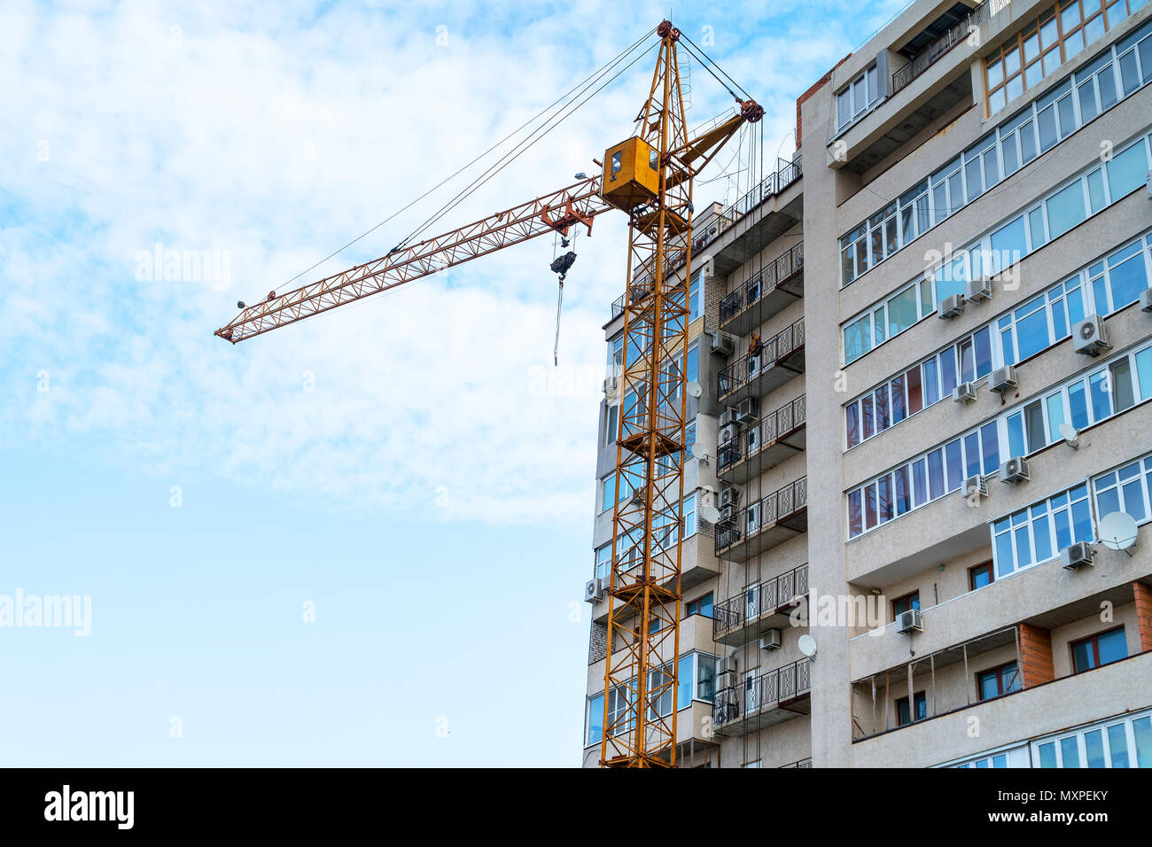 Construction crane against the building Stock Photo - Alamy