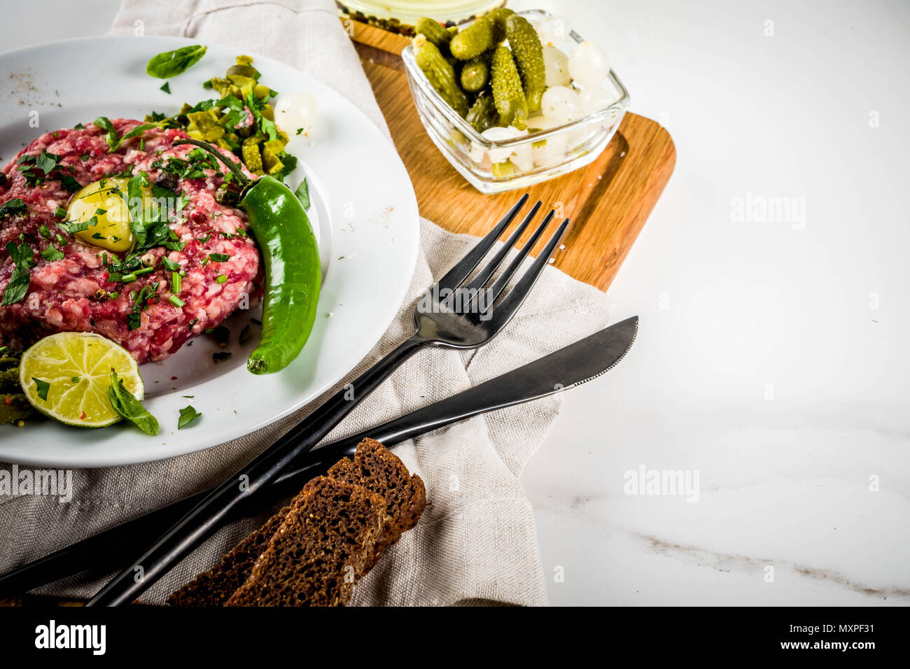 French cuisine, beef steak tartare with raw quail egg yolk, pickled ...