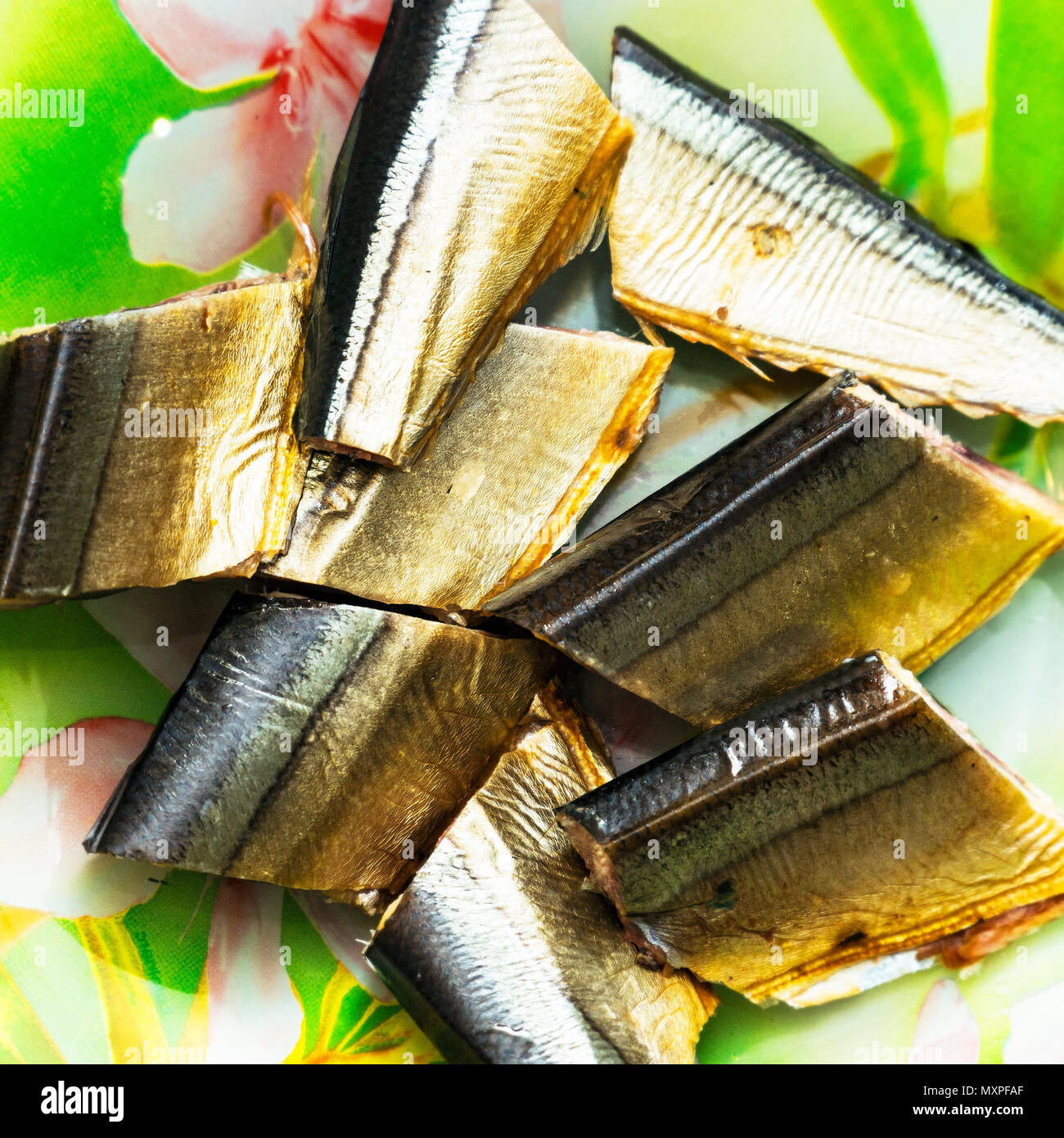 Slices of smoked saury fish on plate Stock Photo - Alamy