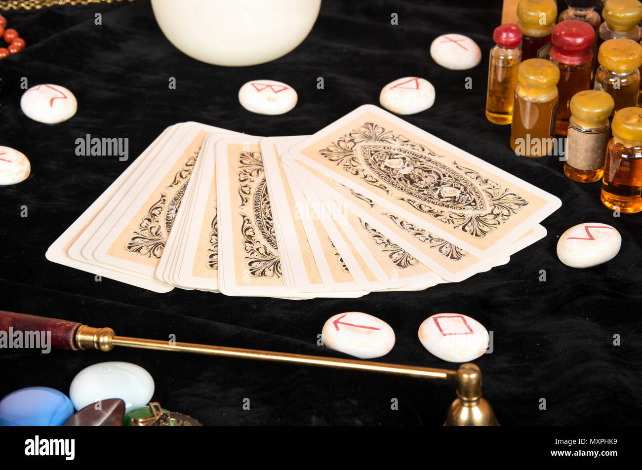 Tarot cards with runes and magical attributes on the table Stock Photo ...