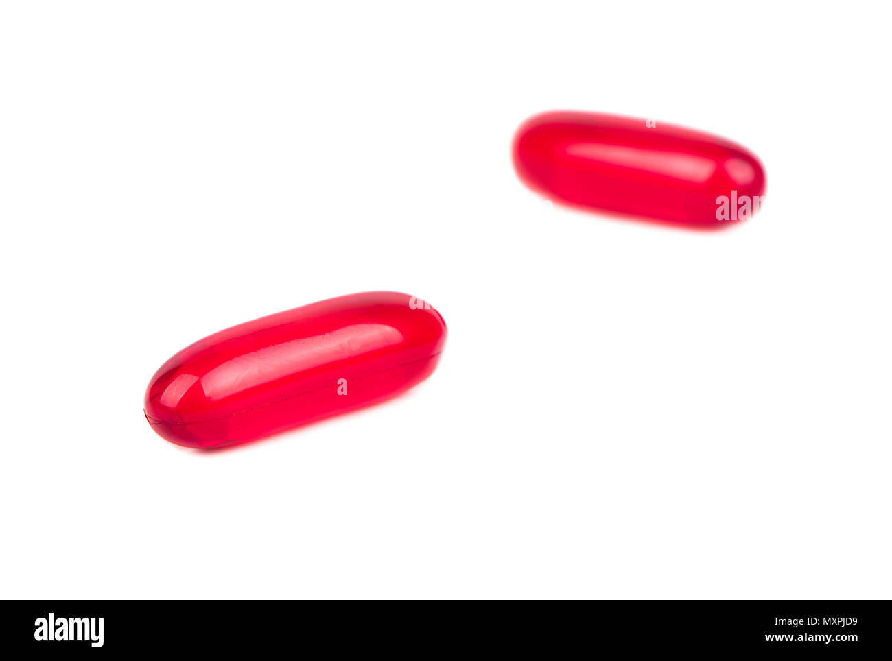 Two red pill capsule isolated on white background Stock Photo - Alamy