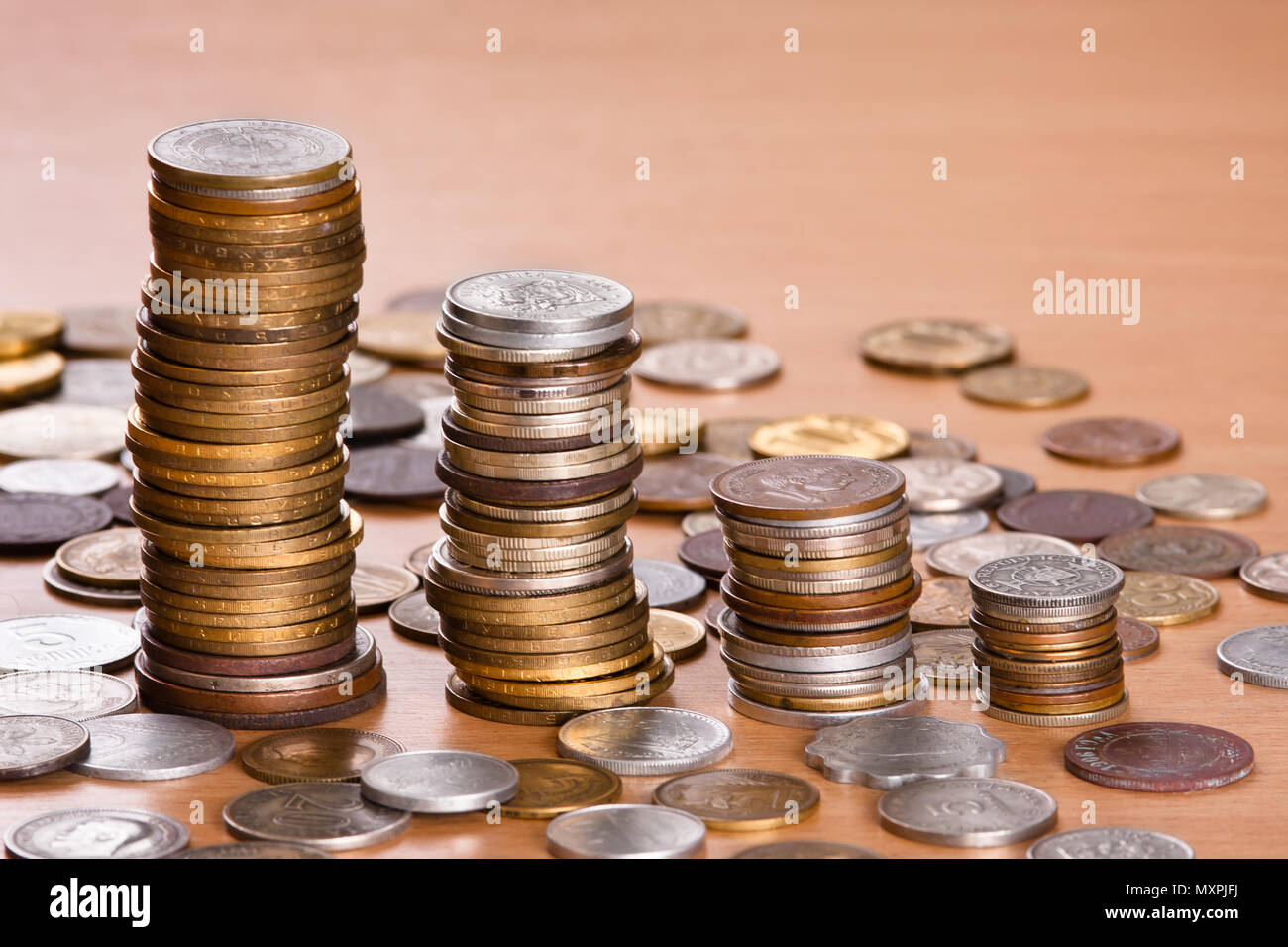 stacks of coin increasing in height on wooden background Stock Photo ...