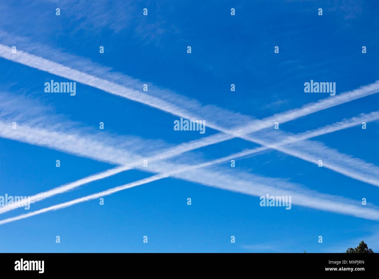 Blue sky with contrails crossing hi-res stock photography and images ...