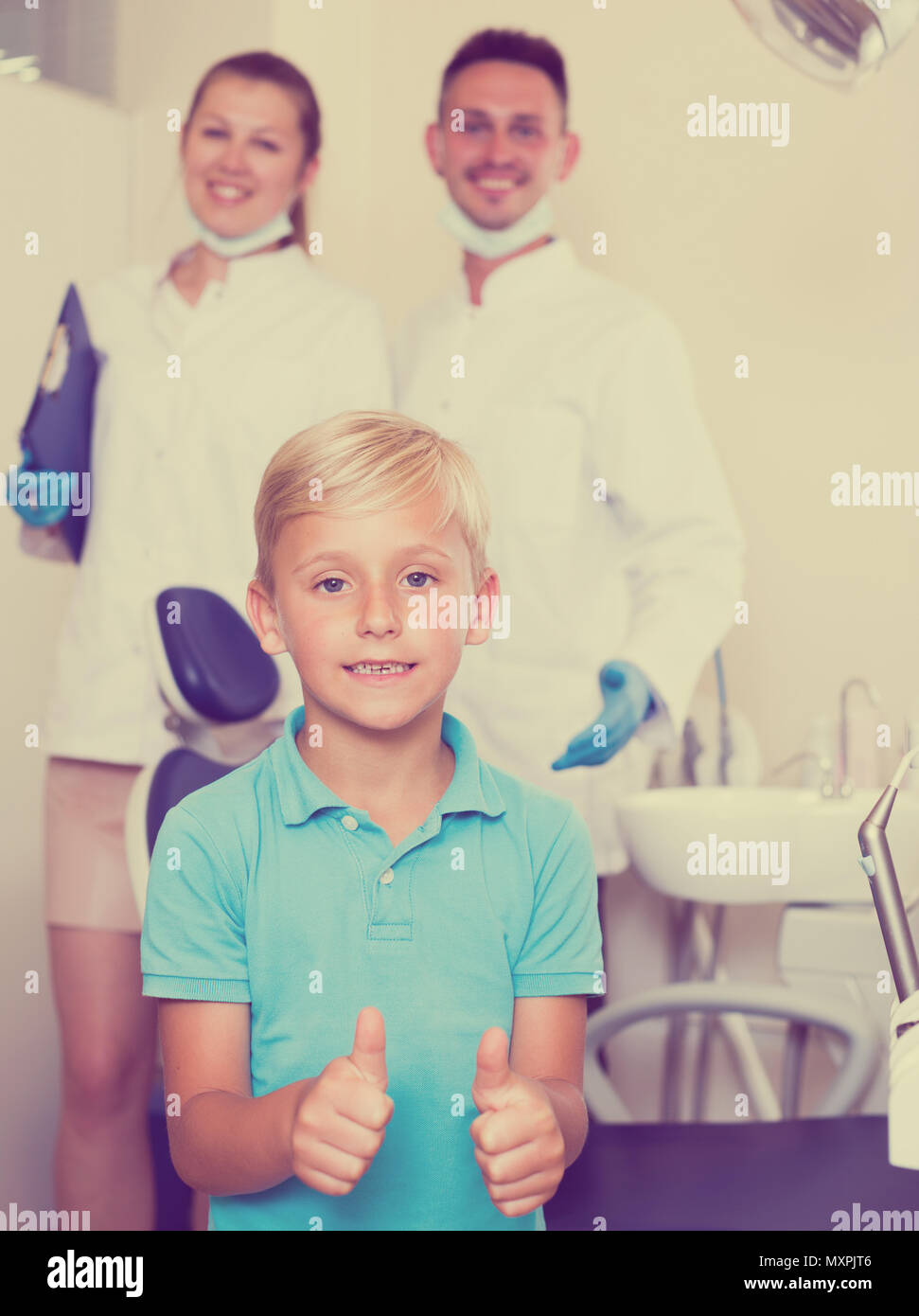 Young smiling visitor is satisfied after visiting of dental office ...