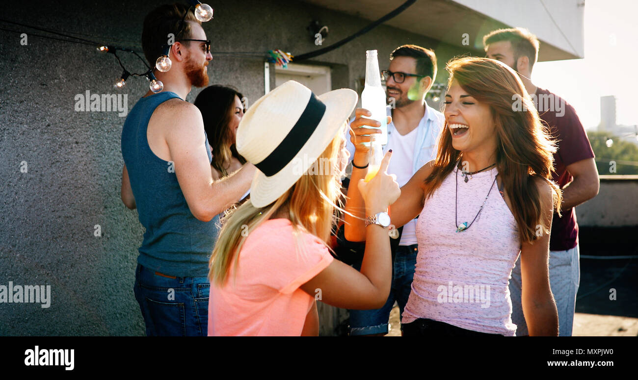 Friends having fun at rooftop party Stock Photo - Alamy