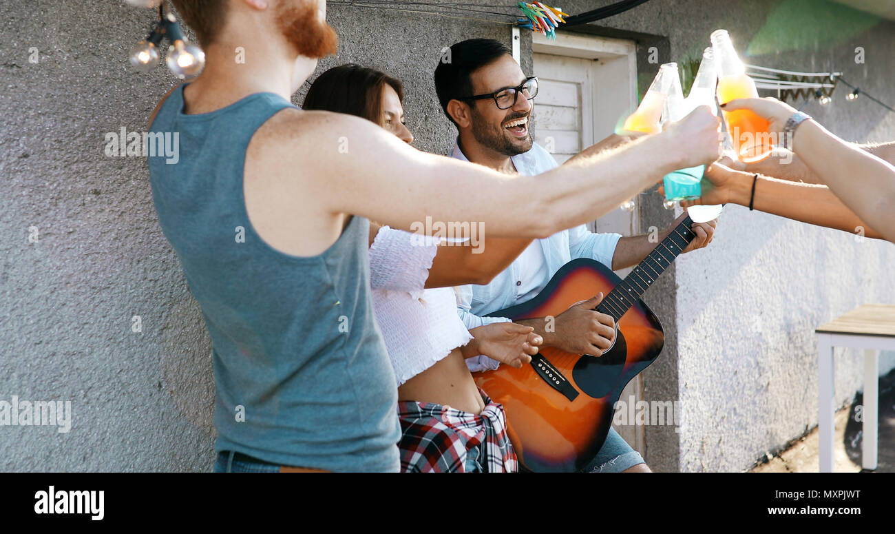 Group of happy friends having party on rooftop Stock Photo - Alamy