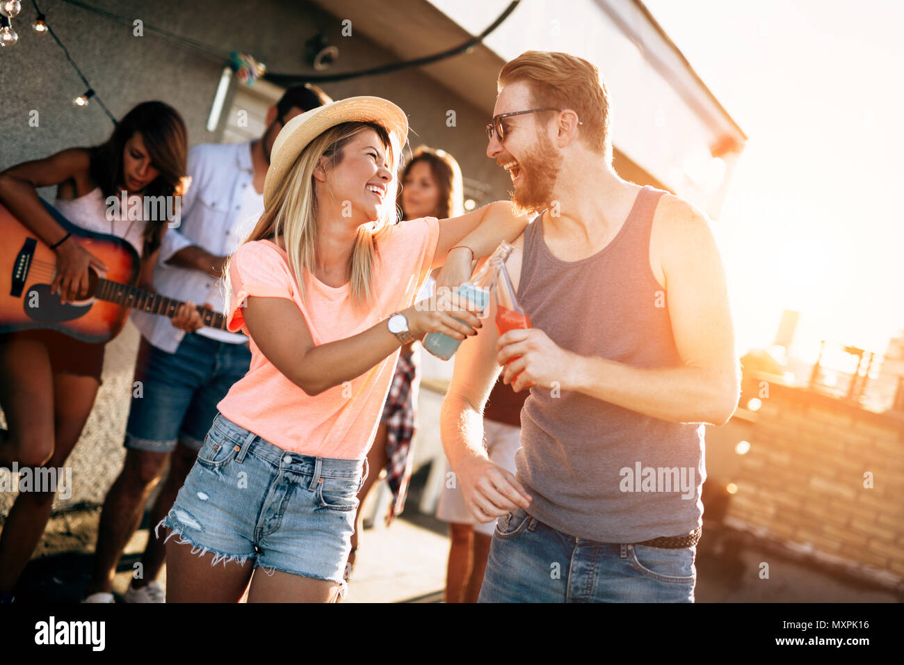 Happy couple having fun time at party Stock Photo - Alamy