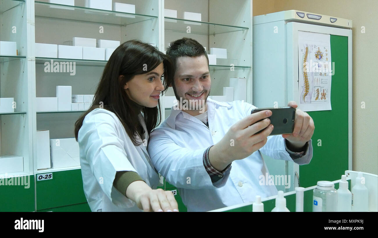 Funny team of pharmacist making selfie pictures at pharmacy Stock Photo ...