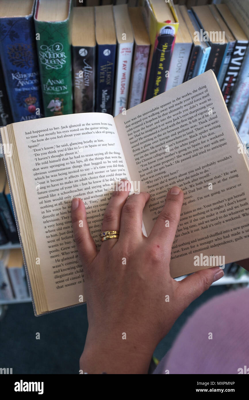 Choosing a book in Library,UK Stock Photo - Alamy
