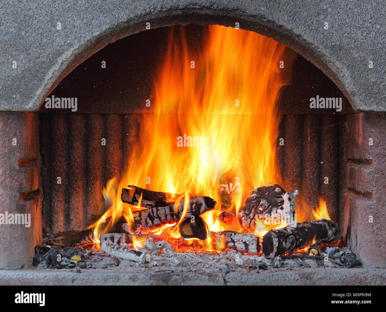 Fireplace with fire at night - outdoor shot Stock Photo - Alamy