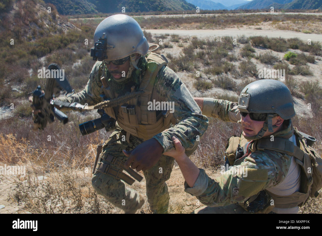 Spc. Aaron Bratcher helps Petty Officer 1st Class ledget Glover climb ...
